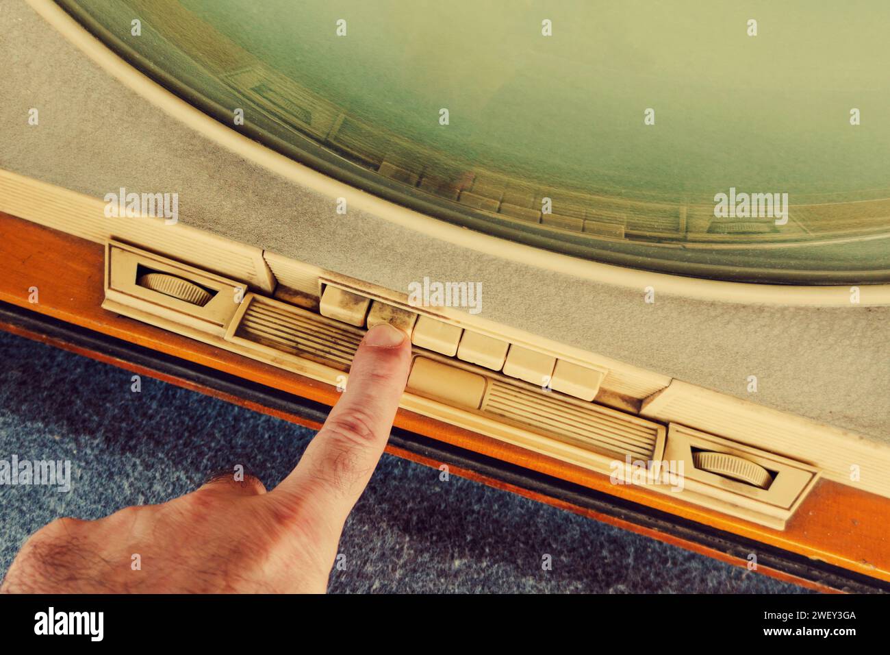 The hand changes channels on the retro old TV. Turning on of the ...