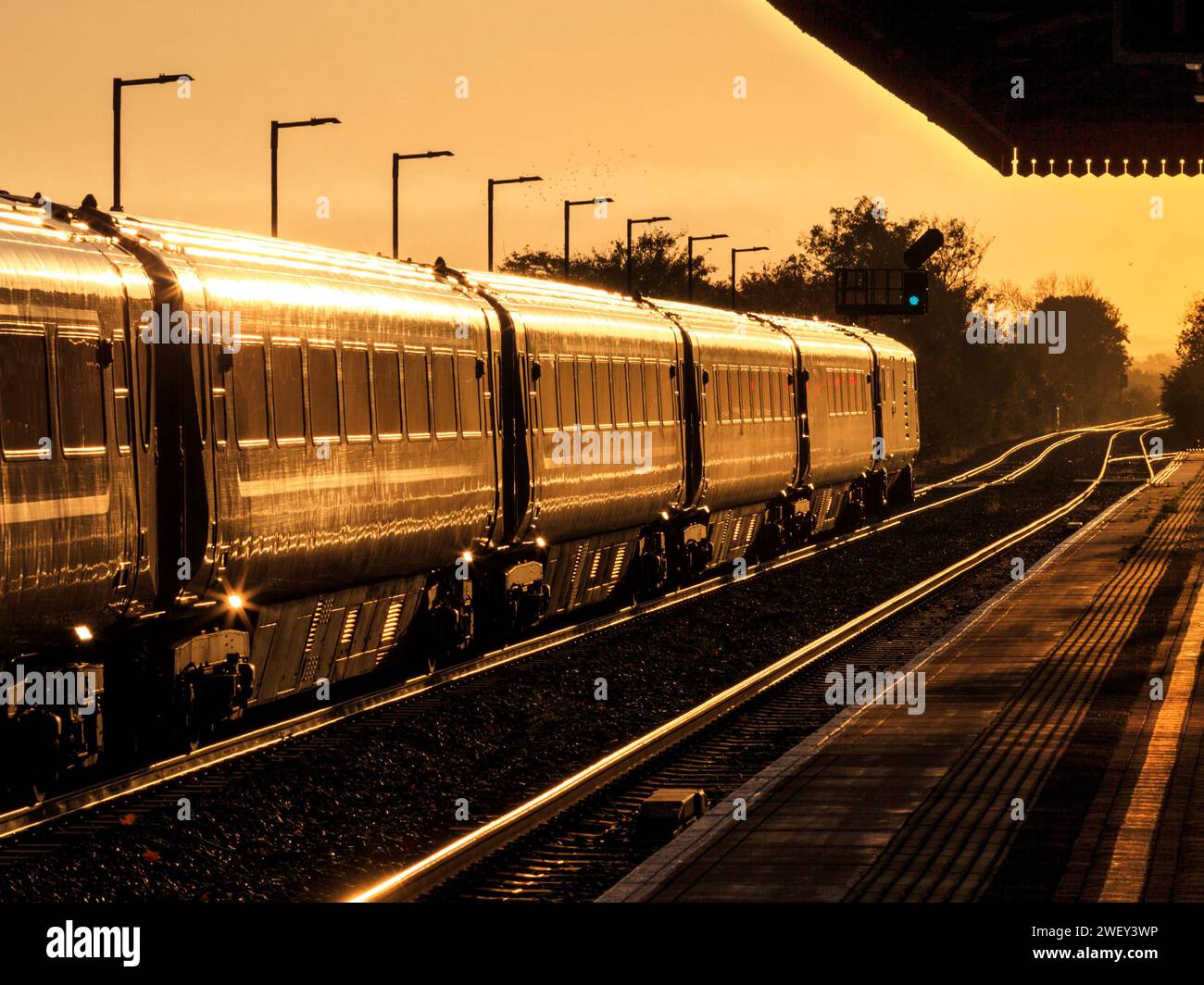 Rising sun glinting off a Chiltern Railways mainline MK3 train at ...