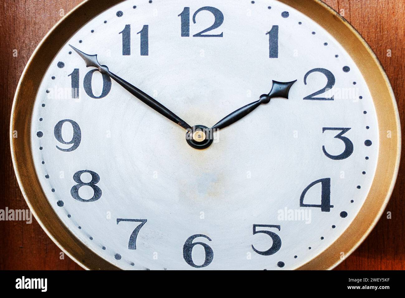 Old vintage clock on a wooden background. Round dial of the wall clock ...