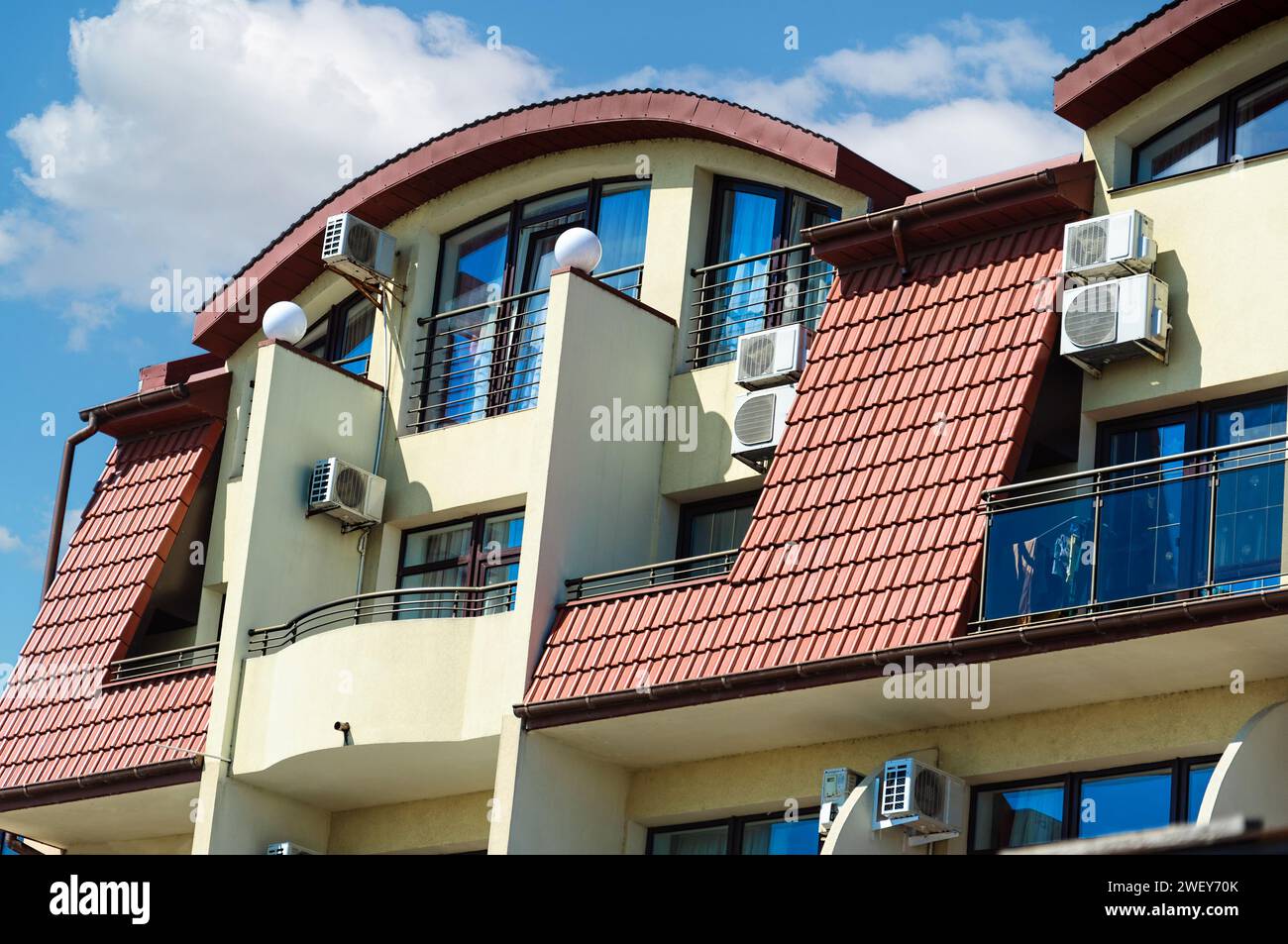 The upper part of the facade of a two-story house of beige color ...