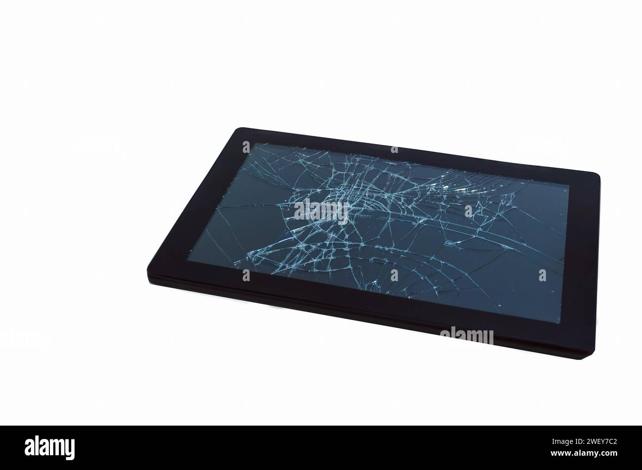 A broken tablet computer as detailed close-up shot on neutral white ...