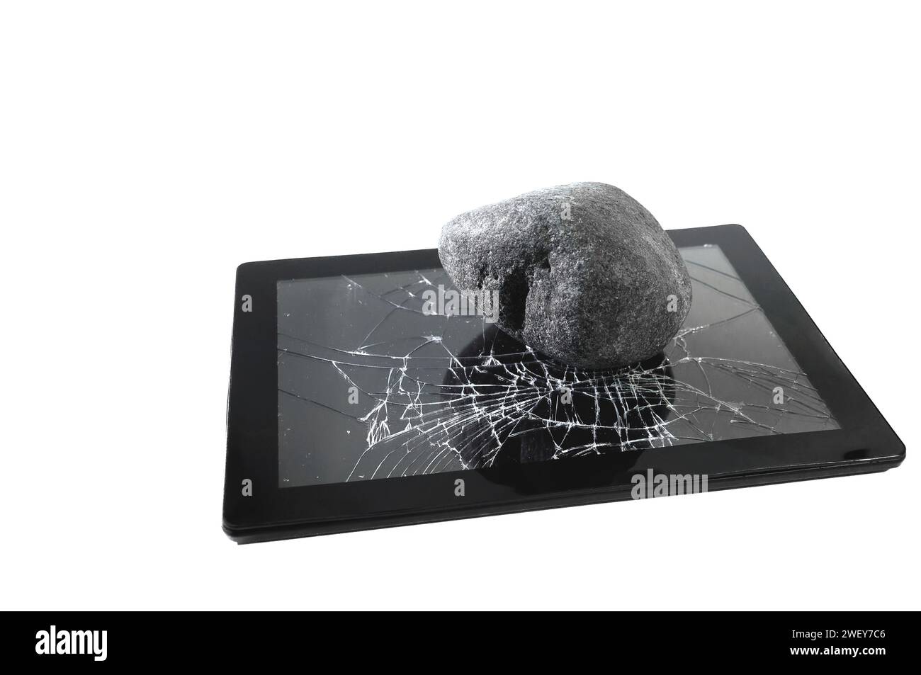 A broken tablet computer as detailed close-up shot on neutral white ...