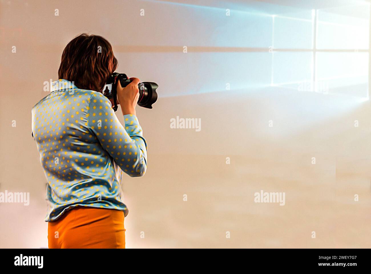 Photographer with a camera. The photographer photographs a meeting. The ...