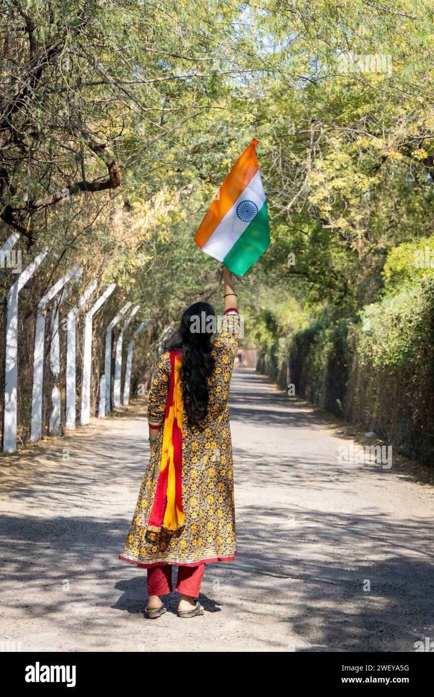 young girl waving the indian tricolor national flag at remote location ...