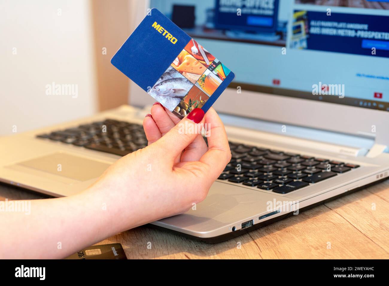 Hand with a card on a laptop background. buyer, Shopper.concept ...