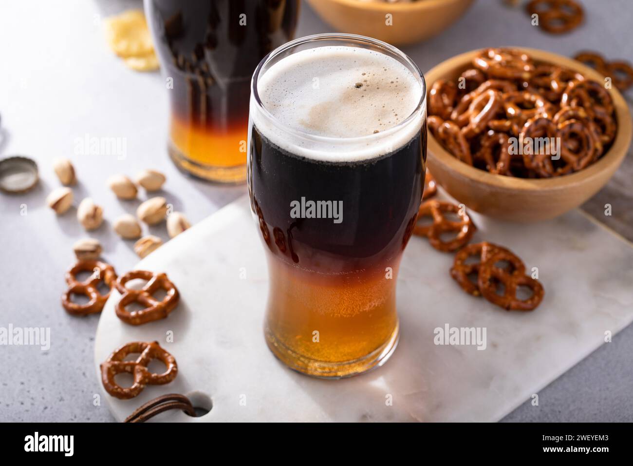 Black and tan cocktail with pale ale and dark stout beer, traditional ...