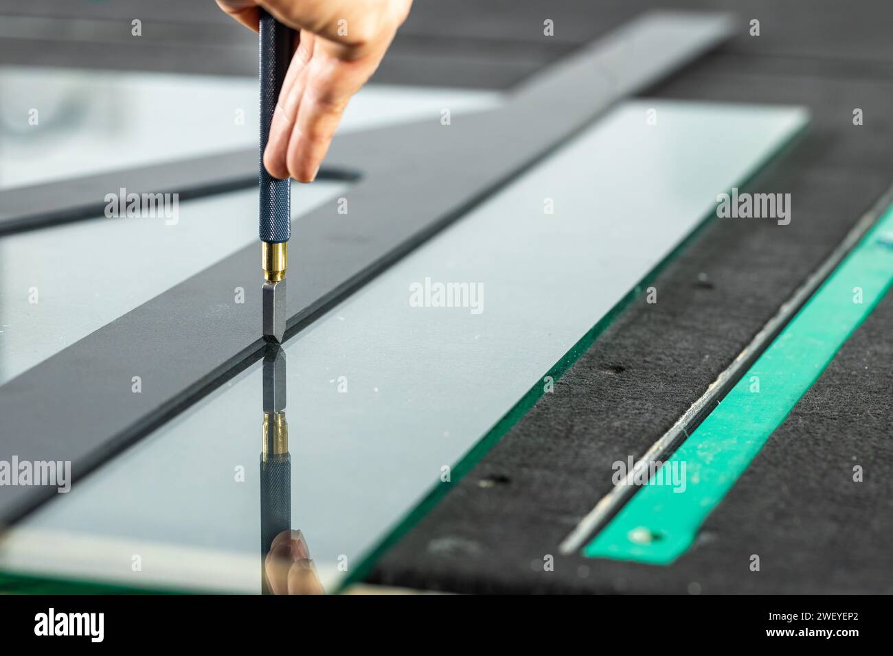 A glazier cuts thick glass on a specialized table, Concept, Glass work ...