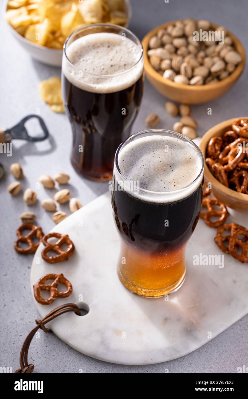 Black and tan cocktail with pale ale and dark stout beer, traditional ...