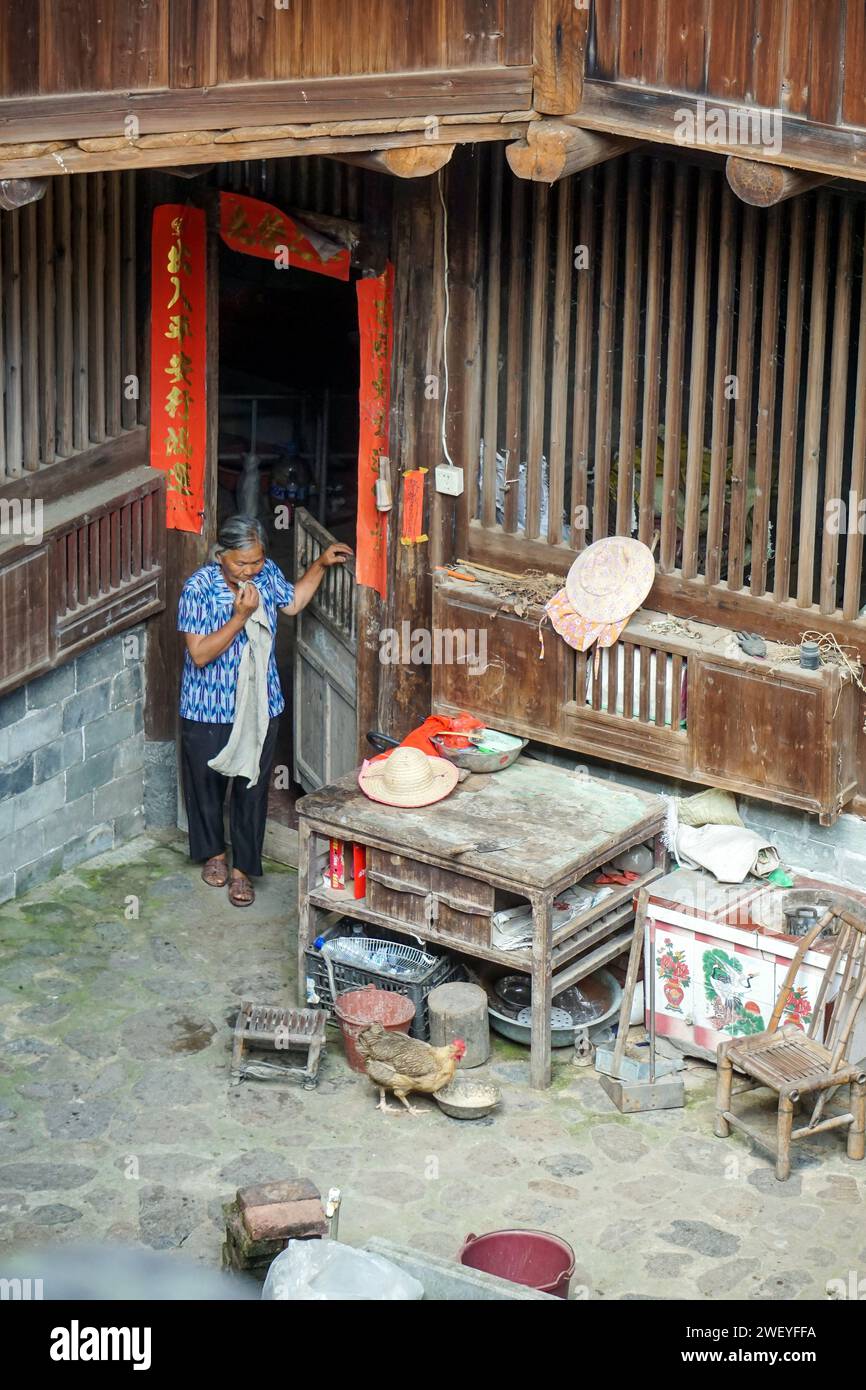 open air cooking in the courtyard of a Hakka Tulou (building made of ...