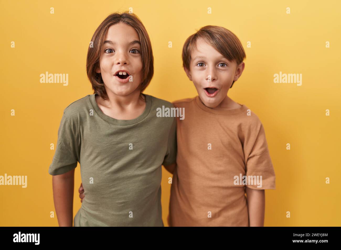 Adorable boys hugging in astonishment, open-mouthed disbelief reaction ...