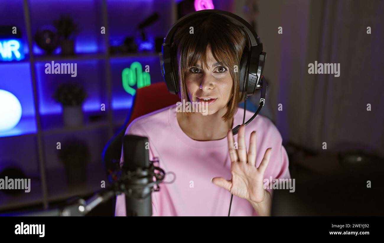 Confident young hispanic woman streamer smiling and speaking up during ...