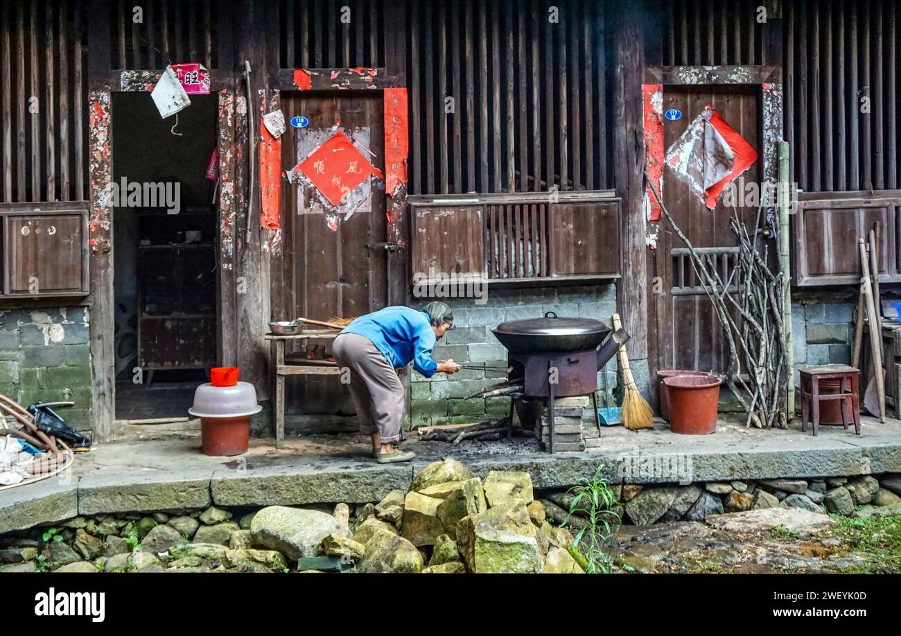 open air cooking in the courtyard of a Hakka Tulou (building made of ...