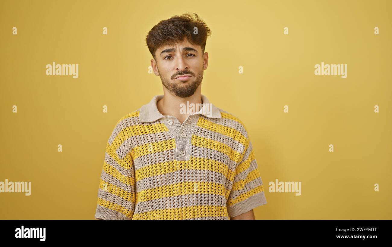 Stylish young arab man coolly bears his serious expression, standing ...