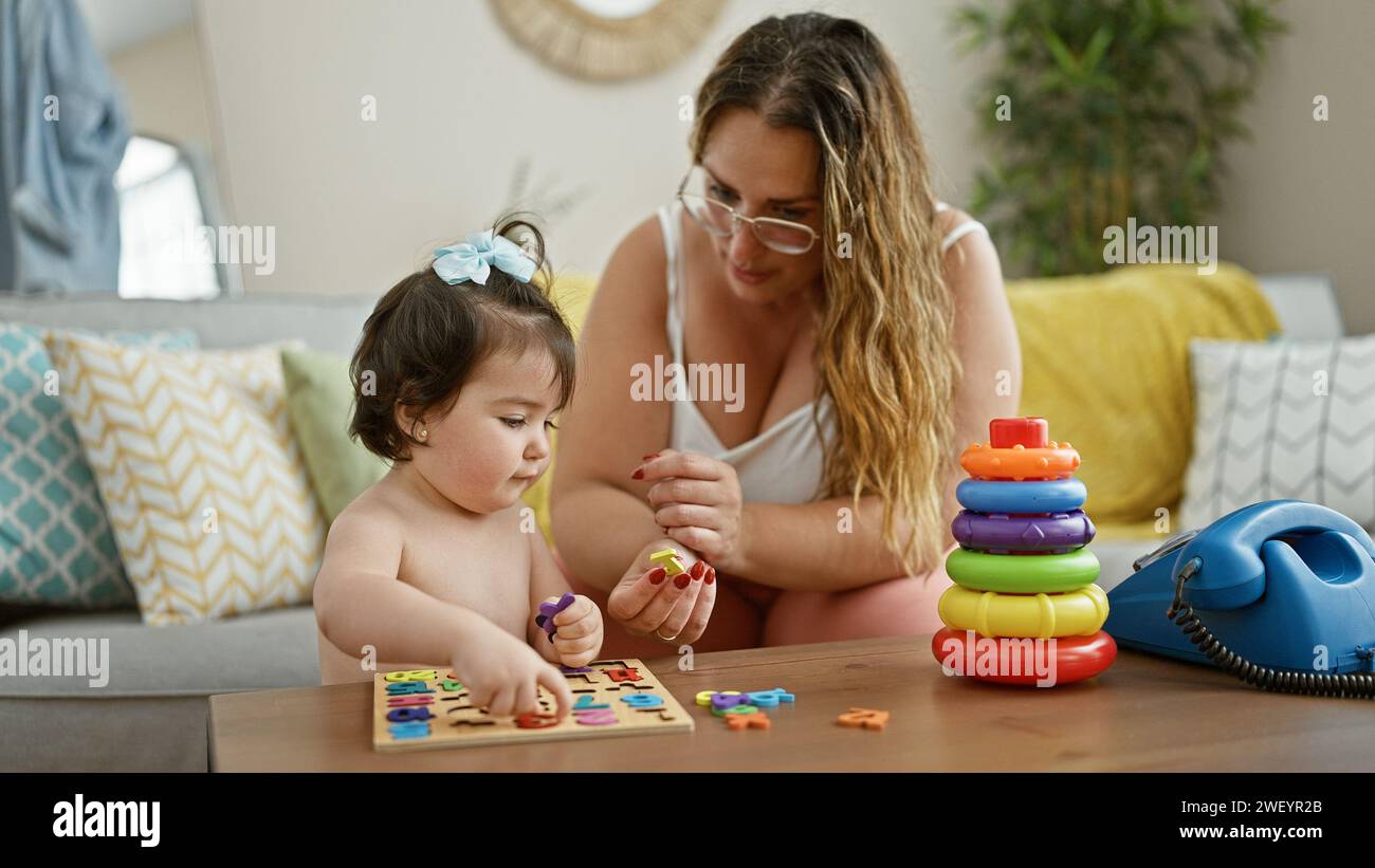 Mother and daughter share a lovely learning moment together, playing a mathematics game on the ...