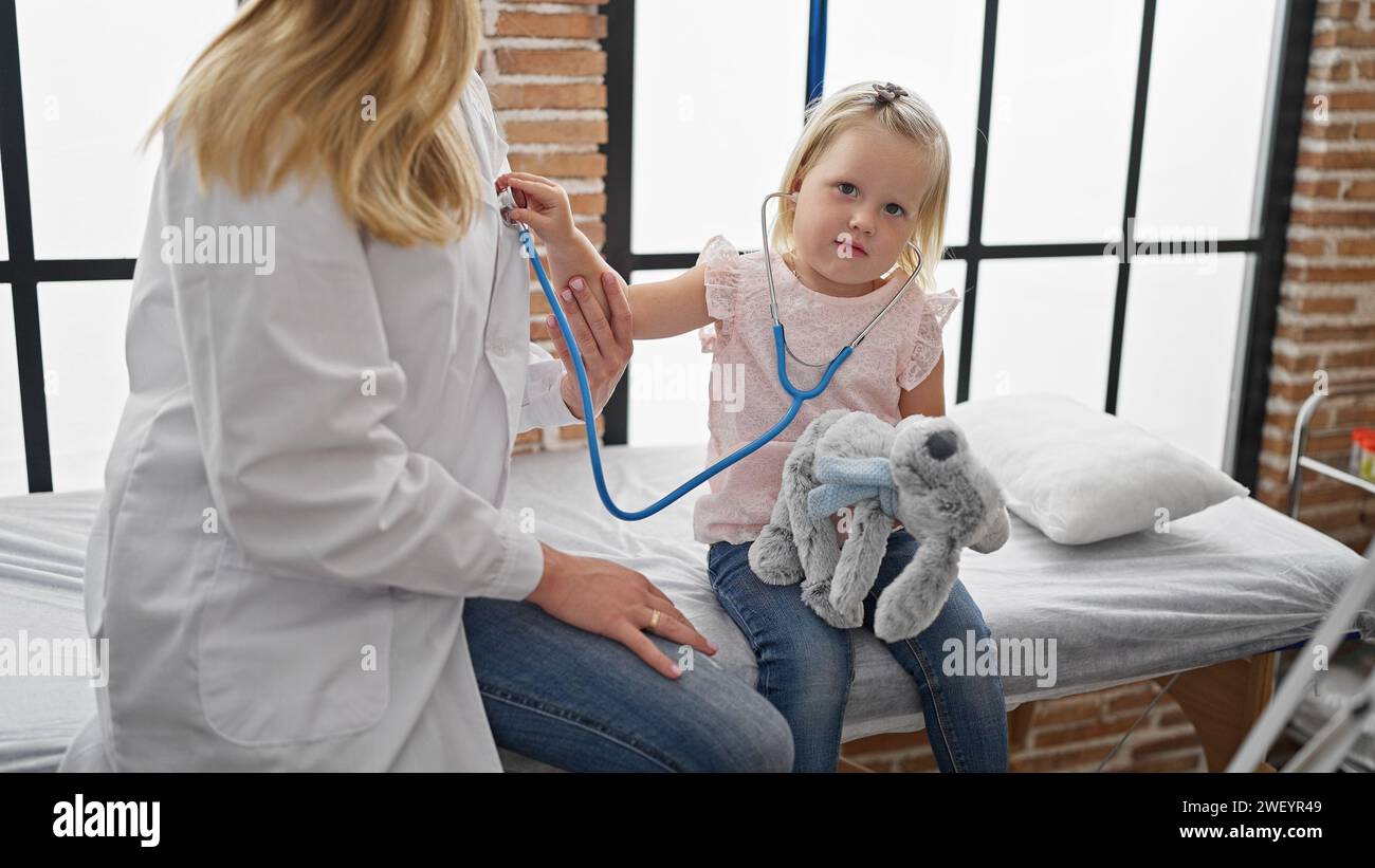 Adorable kid play-examining with doc using stethoscope at clinic, best ...