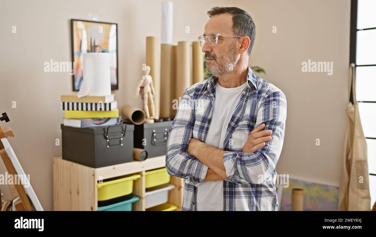 Grey-haired middle-aged artist in serious concentrate mode, standing ...