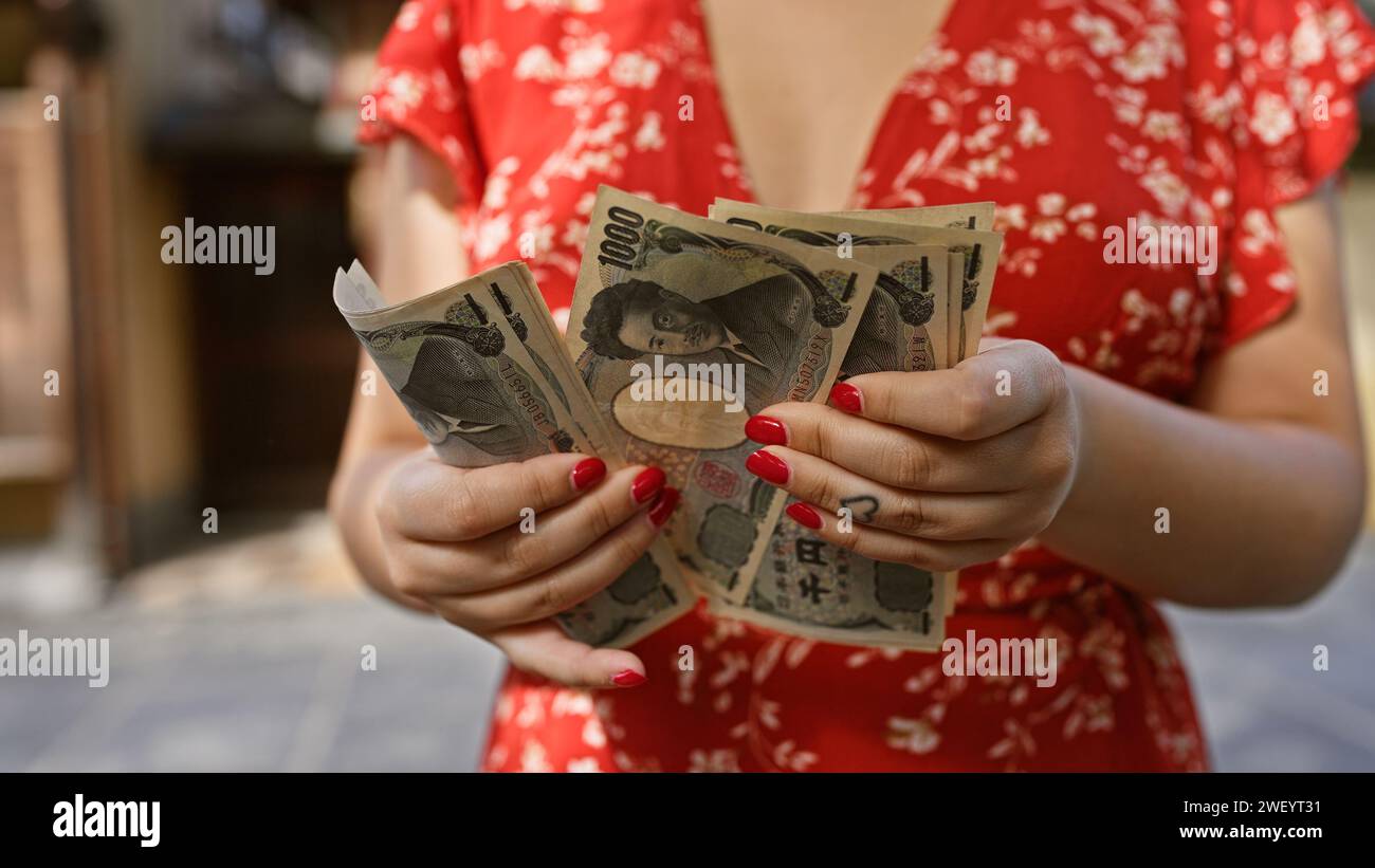 Young woman's hands, busy counting yen banknotes in the traditional ...