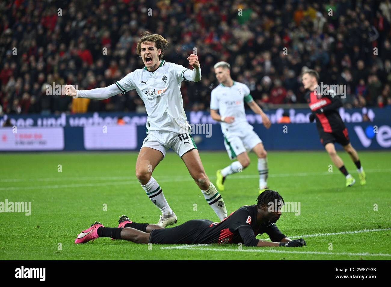 Monchengladbach's Florian Neuhaus, centre, gestures as Leverkusen's ...