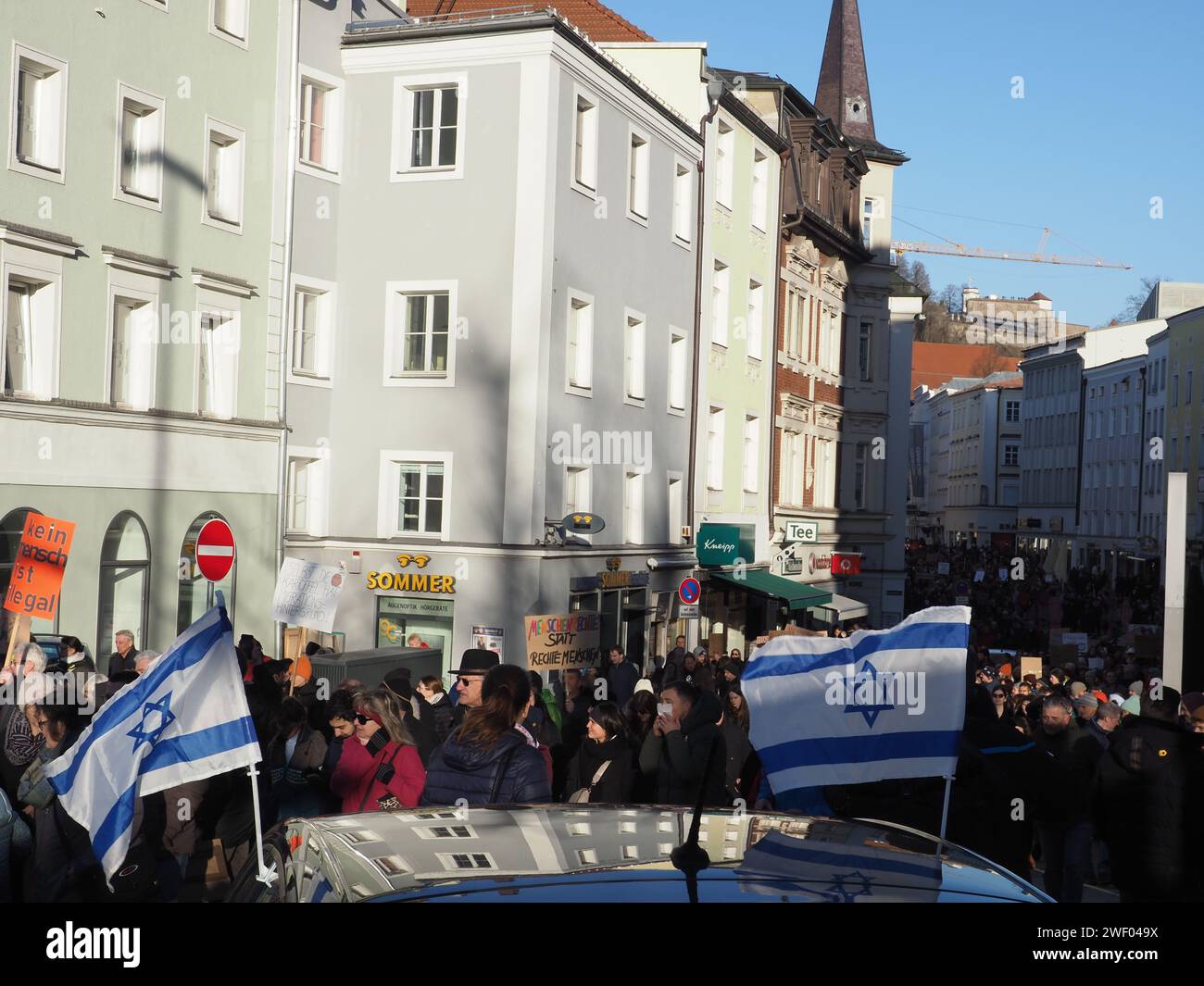 Participants in an anti-fascist demonstration walk next to a picket of ...