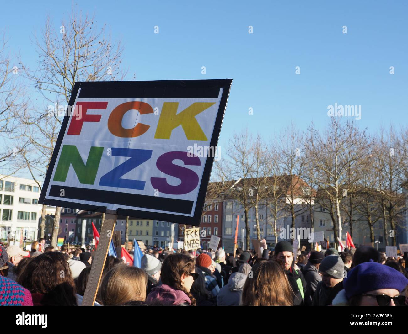 A poster with an abbreviated anti-fascist inscription above the heads ...