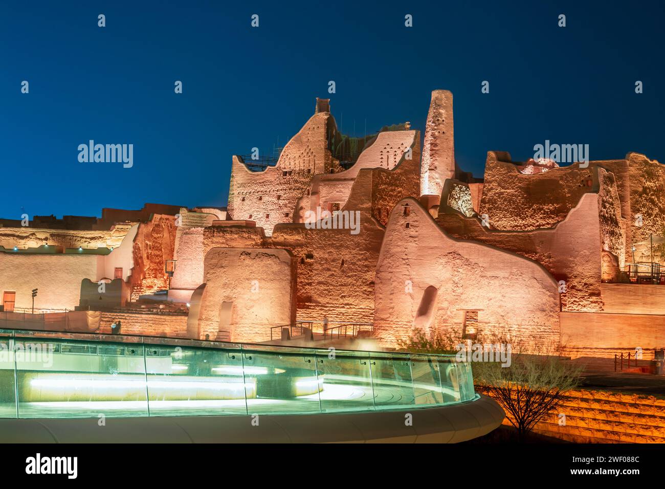 Modern glass passage to Diriyah illuminated old town walls, At-Turaif ...