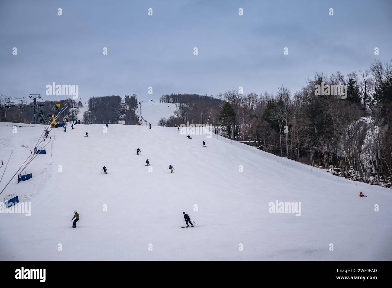 People skiing and snowboarding downhill, Mont Tremblant mountain ...