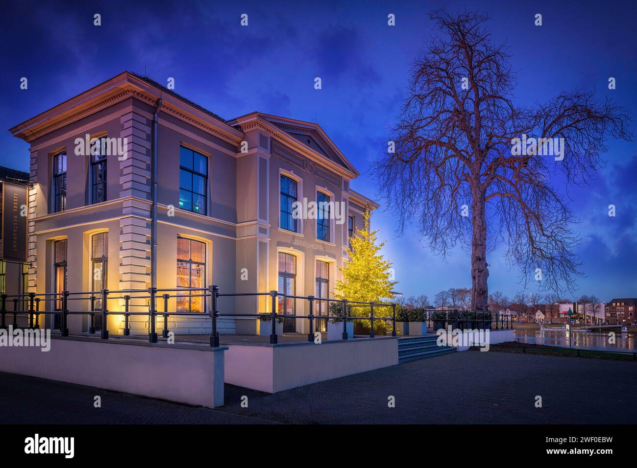 A stunning image of a tall, imposing building illuminated by the night ...