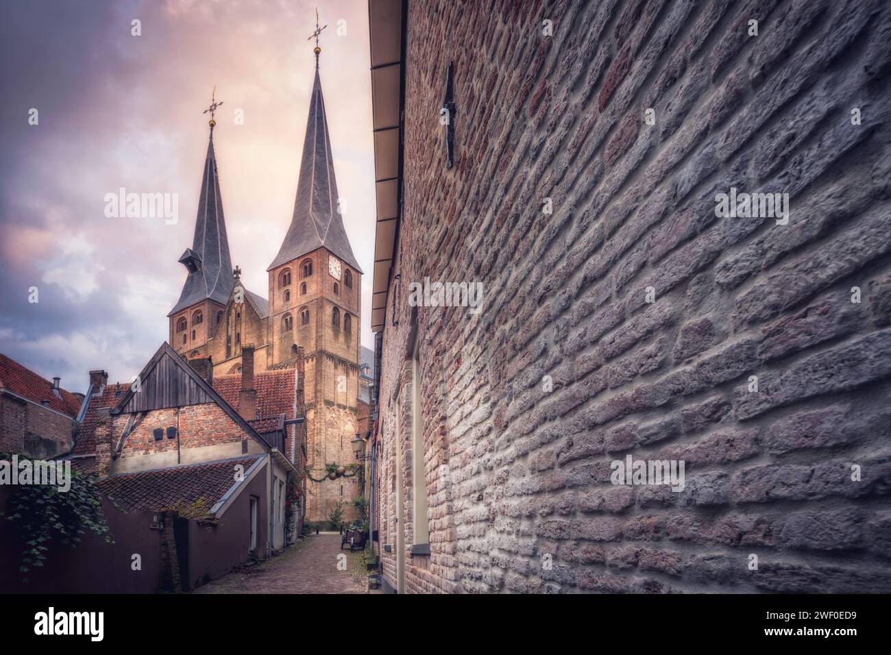 An aerial view of a religious building featuring a spire and adjacent ...
