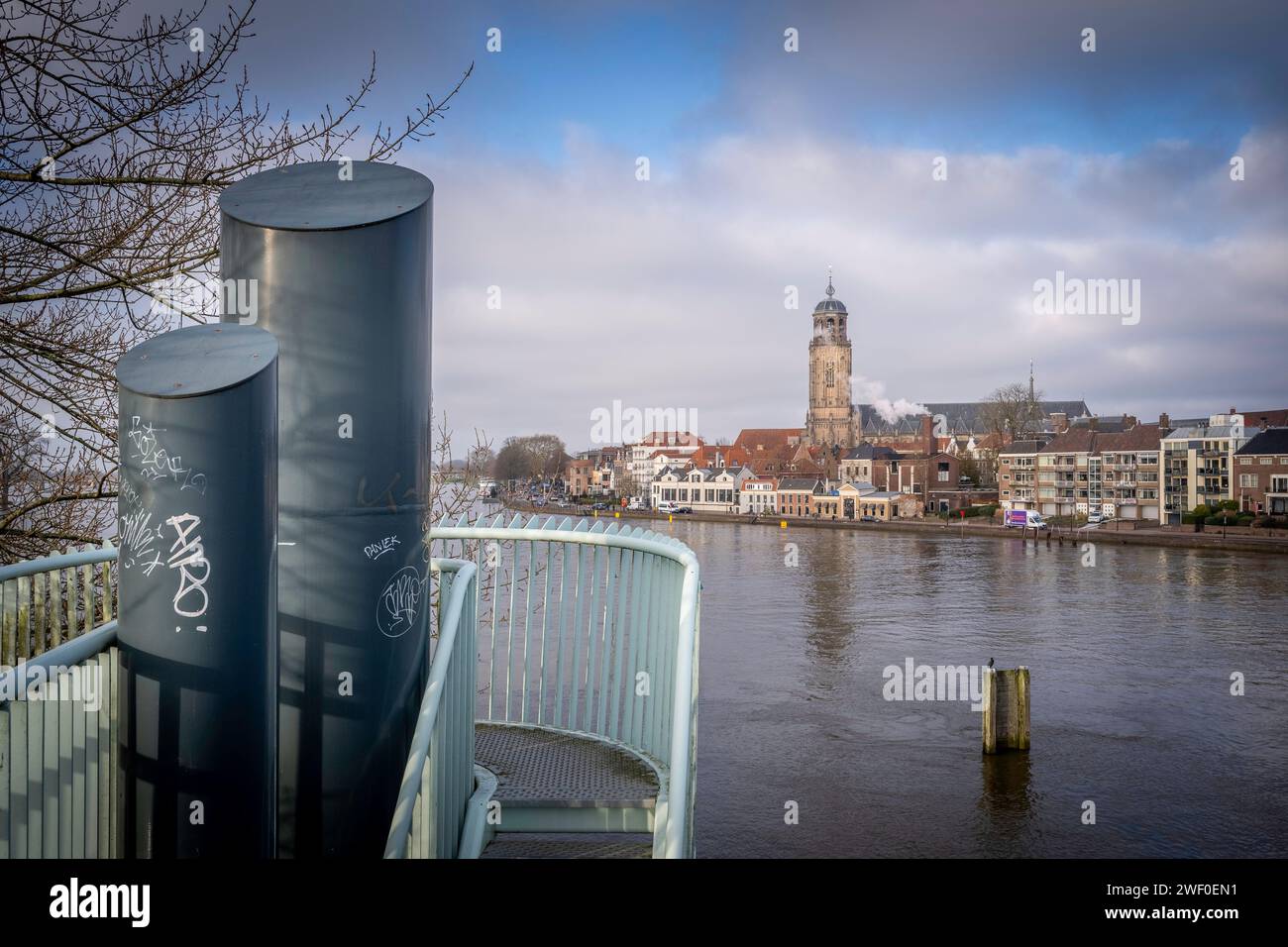 An aerial view of a blue and black pipeline running alongside a body of ...