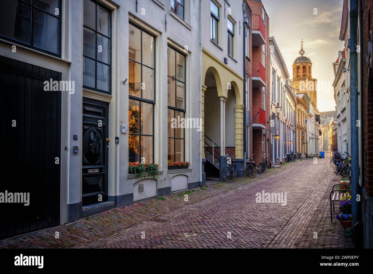 A picturesque alleyway with a row of vibrant, pastel-colored houses in ...
