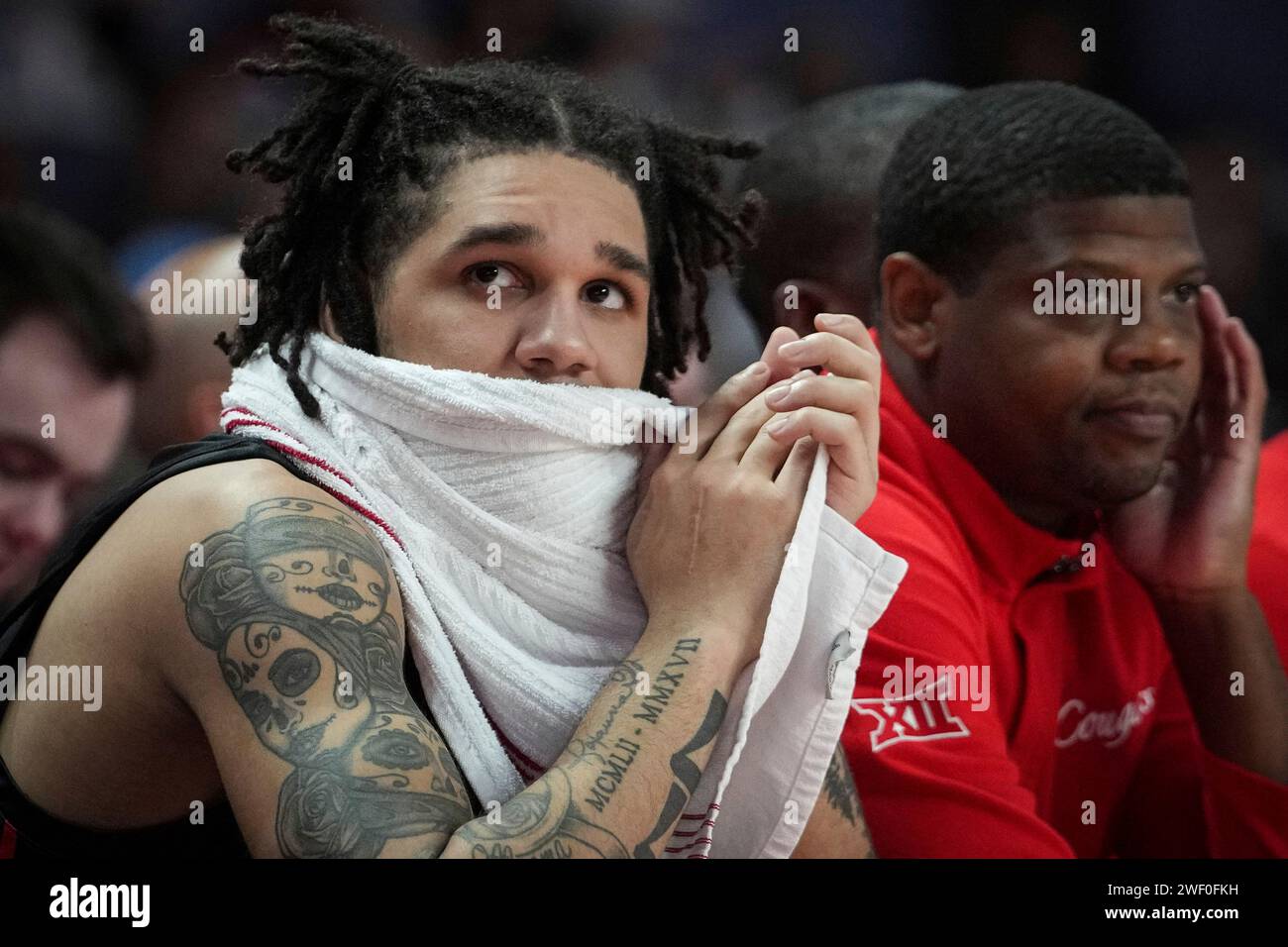Houston guard Emanuel Sharp (21) watches from the bench during the ...
