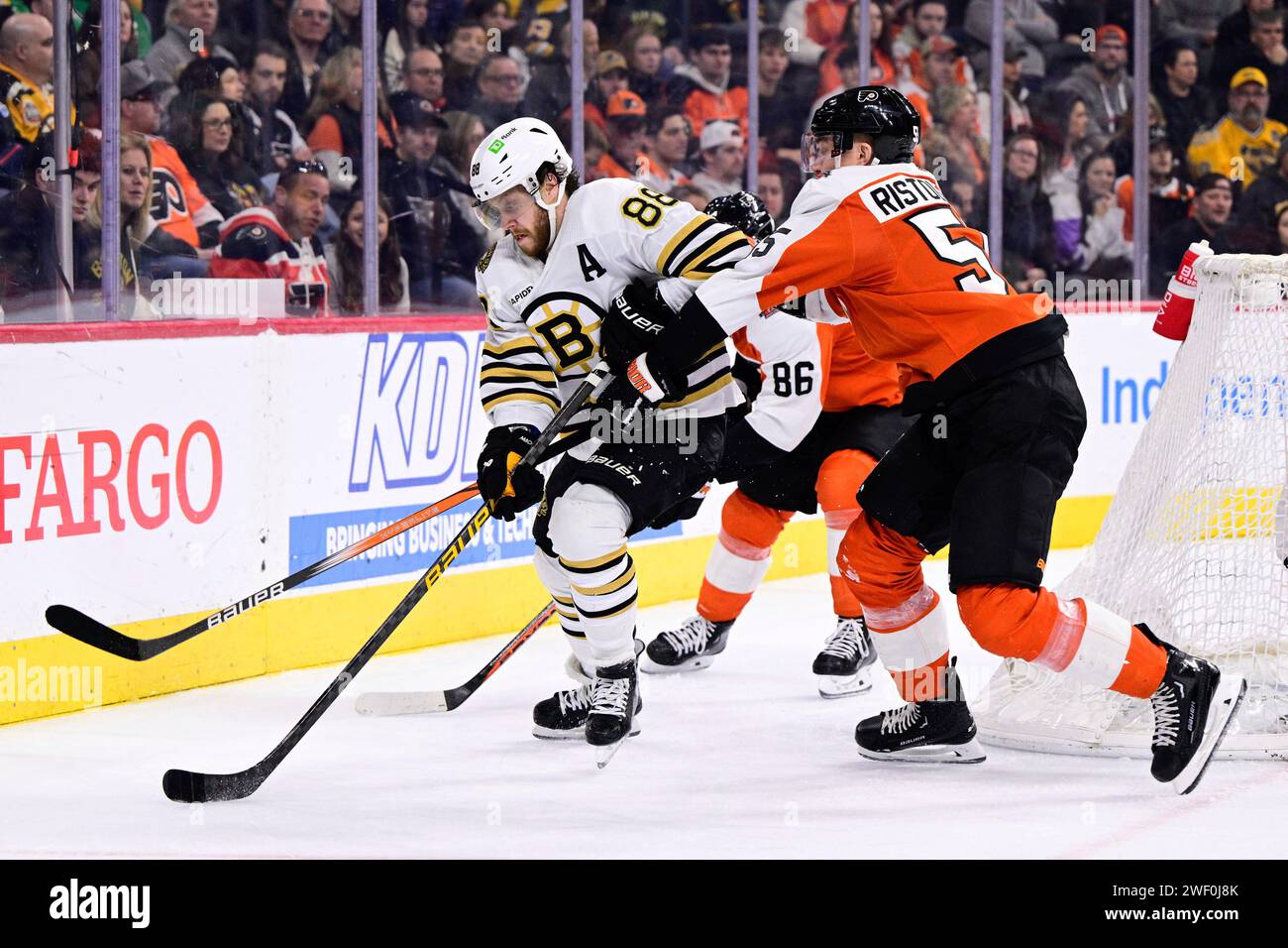 Boston Bruins' David Pastrnak (88) plays the puck past Philadelphia ...