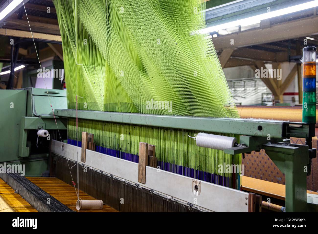 Modern Carpet weaving factory. Carpet making machine needle. Yarn ...