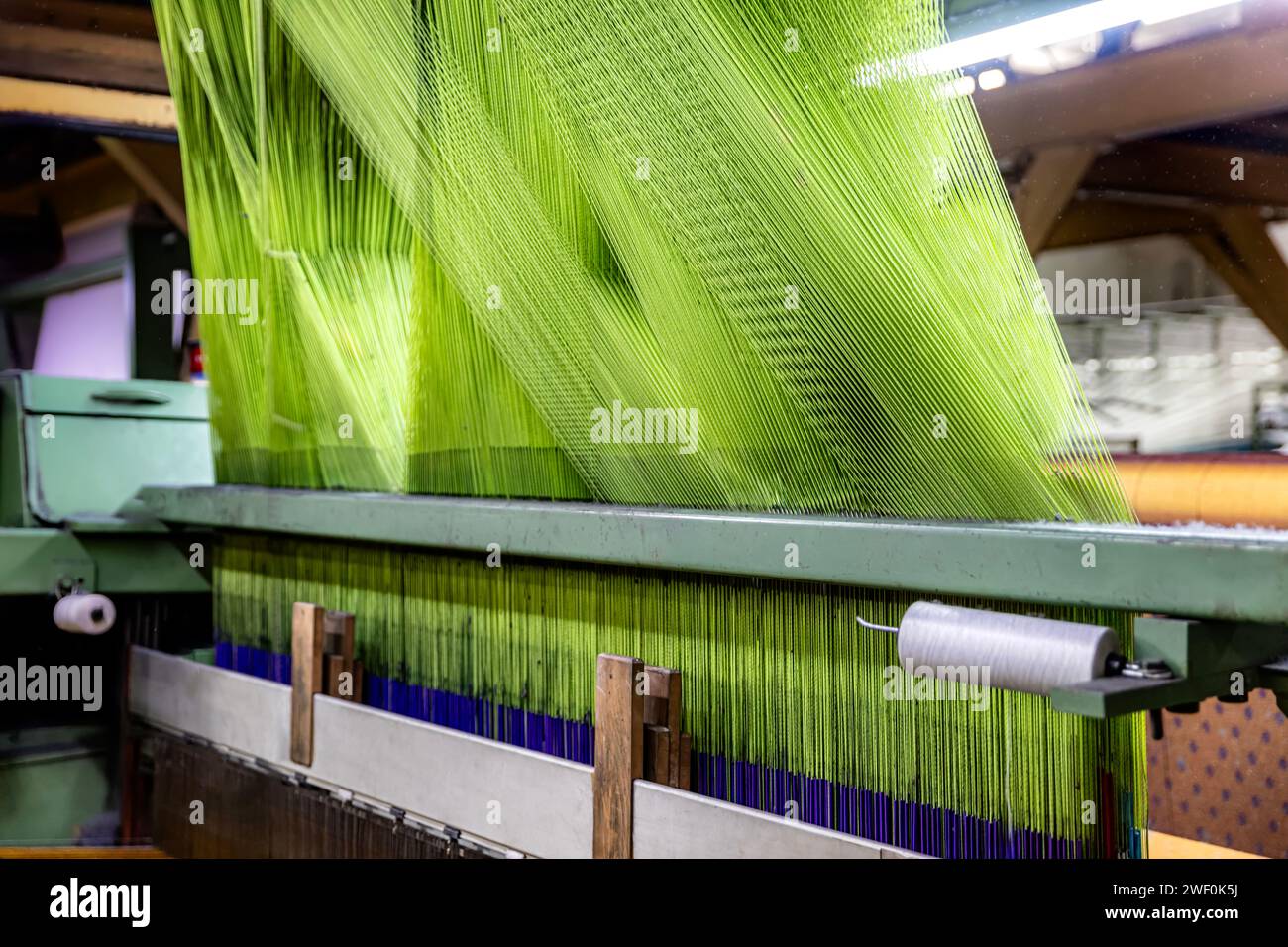 Modern Carpet weaving factory. Carpet making machine needle. Yarn ...