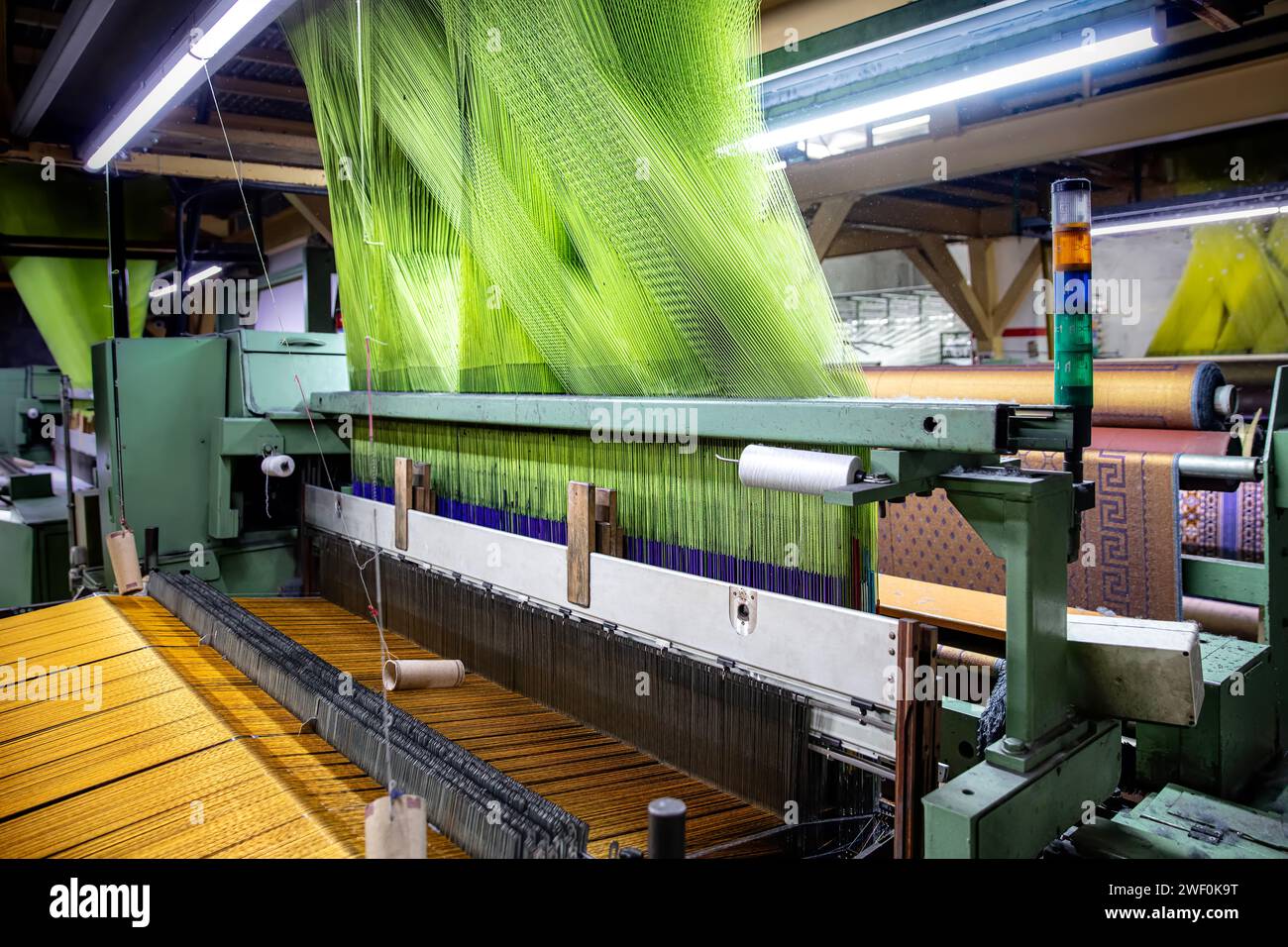 Modern Carpet weaving factory. Carpet making machine needle. Yarn ...