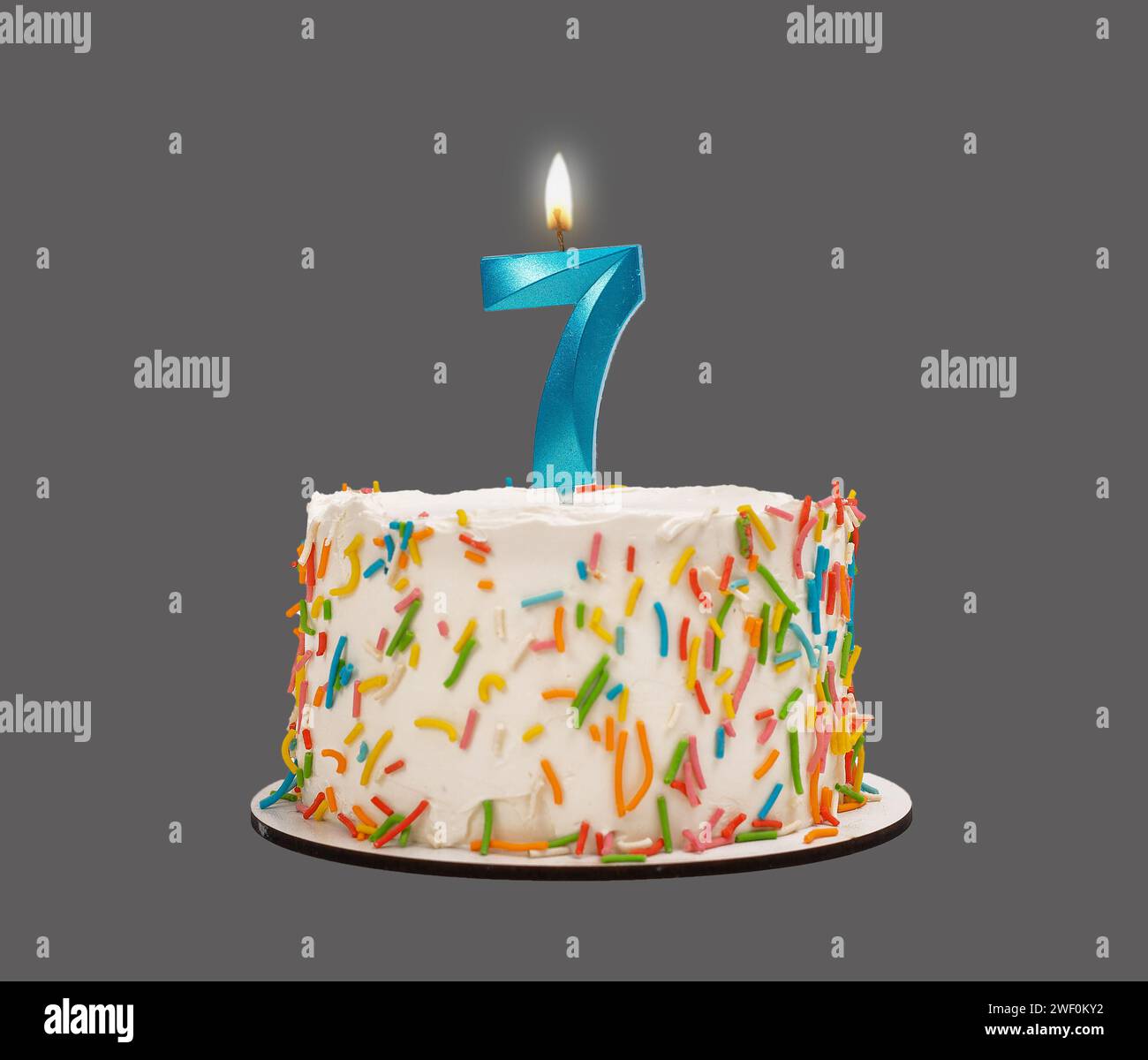 7 shaped candle light on happy birthday cake isolated on white ...