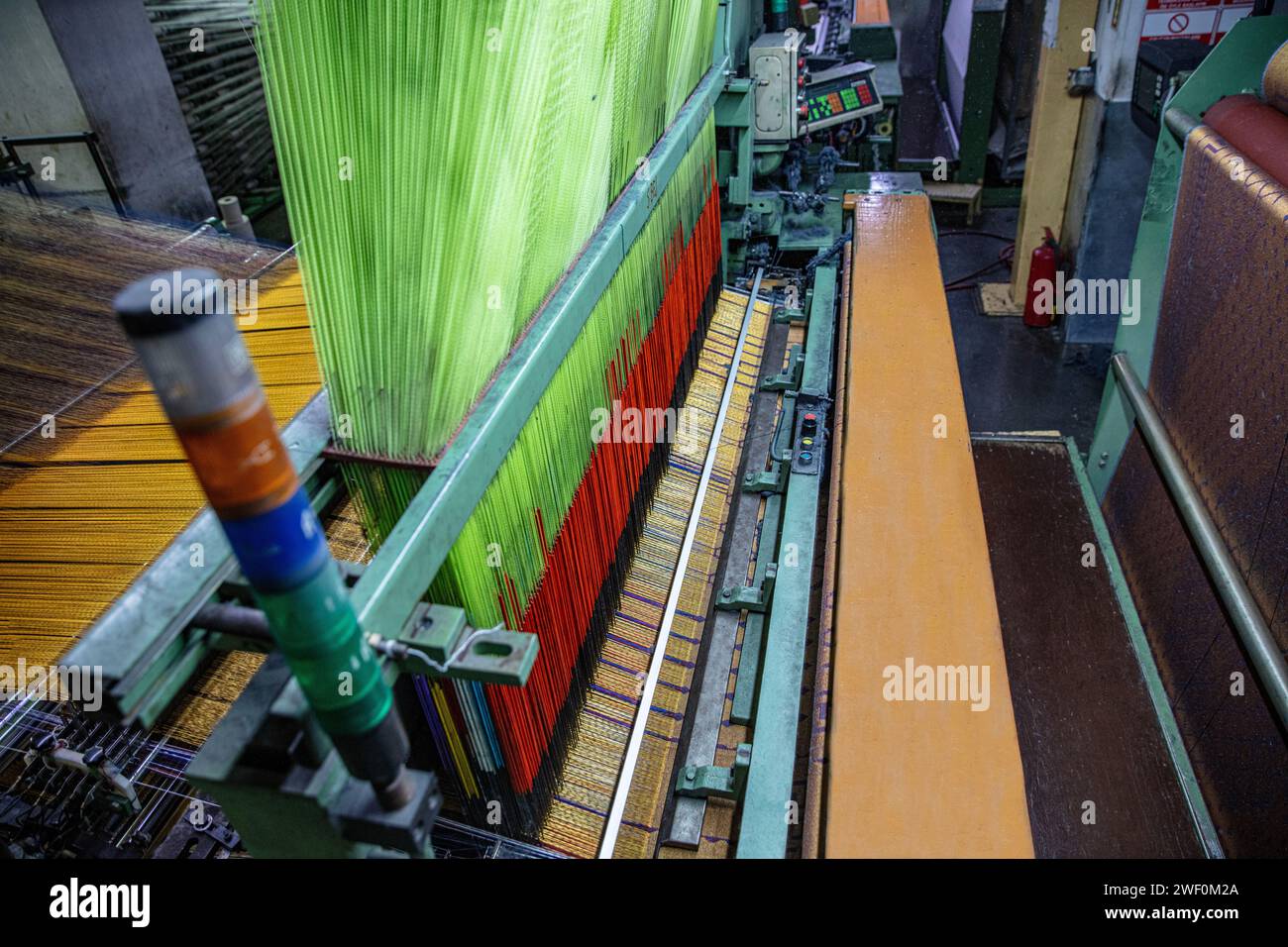 Modern Carpet weaving factory. Carpet making machine needle. Yarn ...