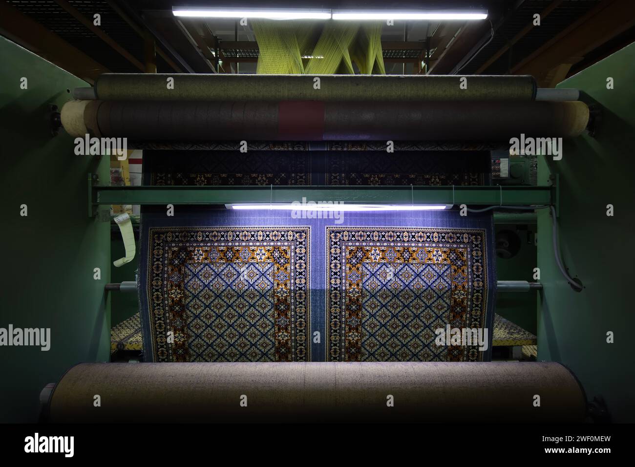 Modern Carpet weaving factory. Carpet making machine needle. Yarn ...