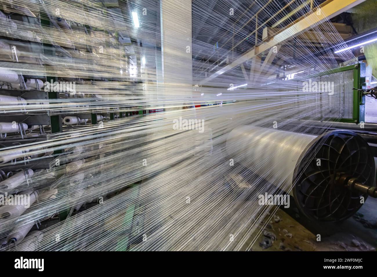 Modern Carpet weaving factory. Carpet making machine needle. Yarn ...