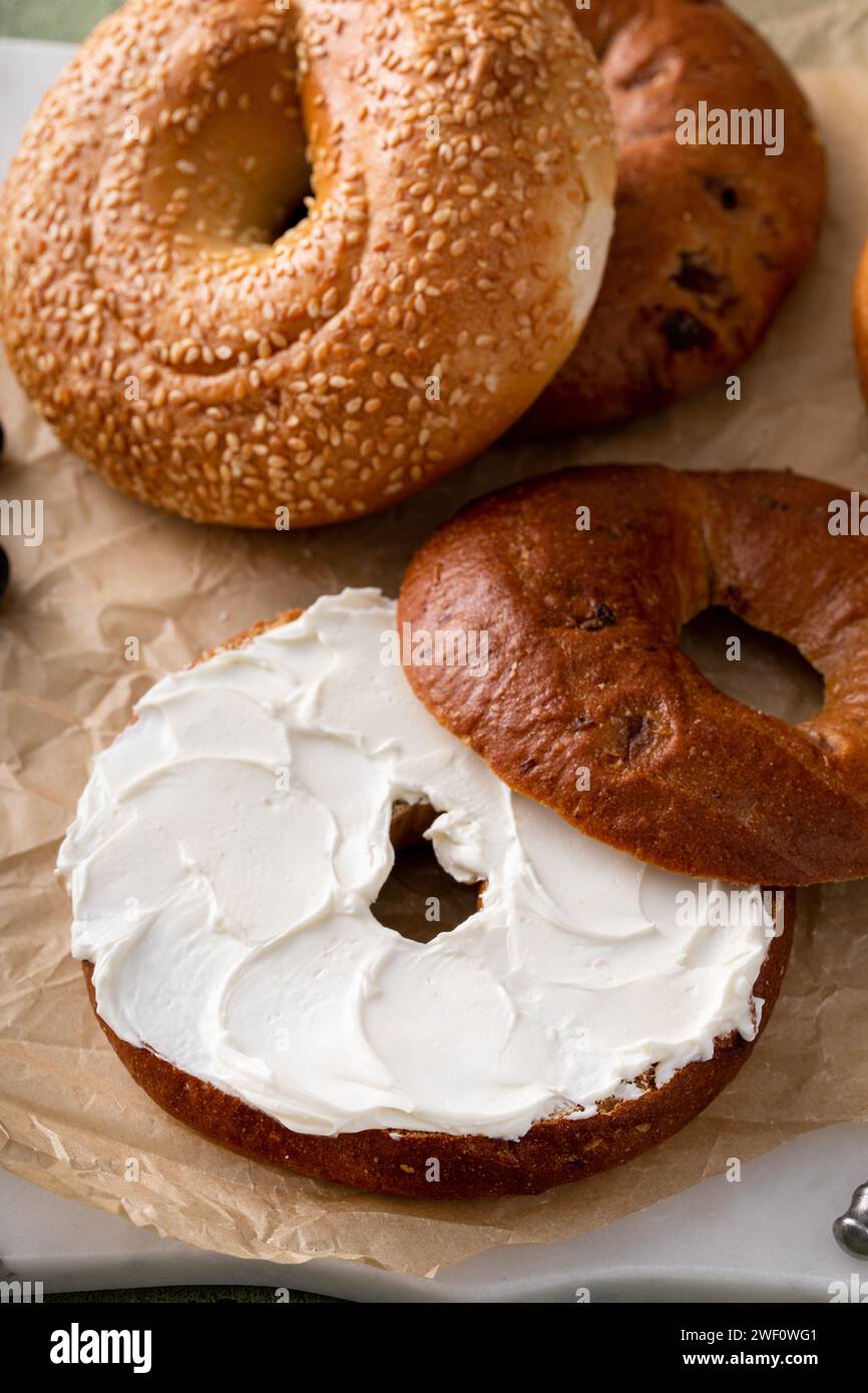 Cinnamon raisin bagel topped with cream cheese for breakfast Stock ...