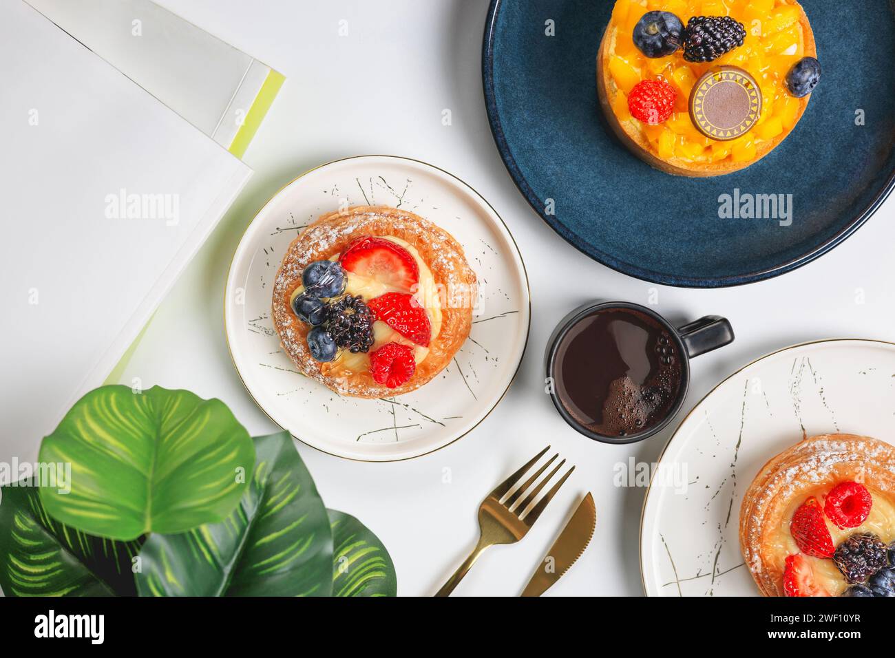 Flat lay composition with delicious berry tartlets on a white ...