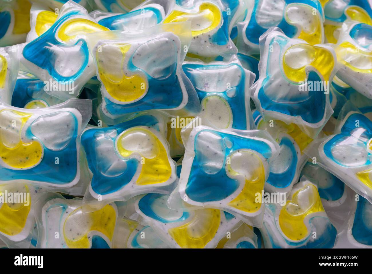 Dishwasher detergent and or laundry soap capsules, close up background ...