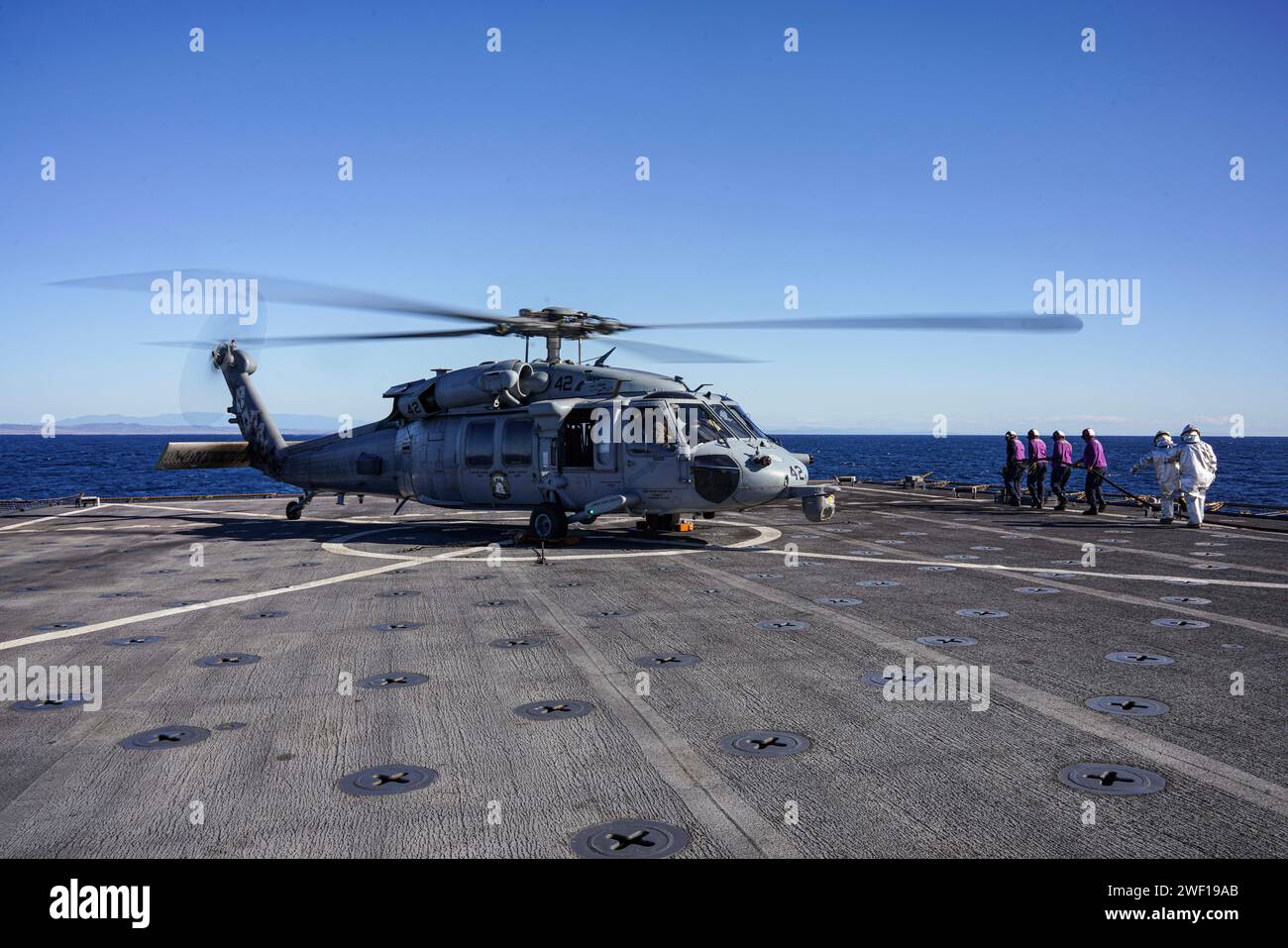 Sailors prepare to refuel an SH-60S Seahawk, attached to Helicopter Sea ...