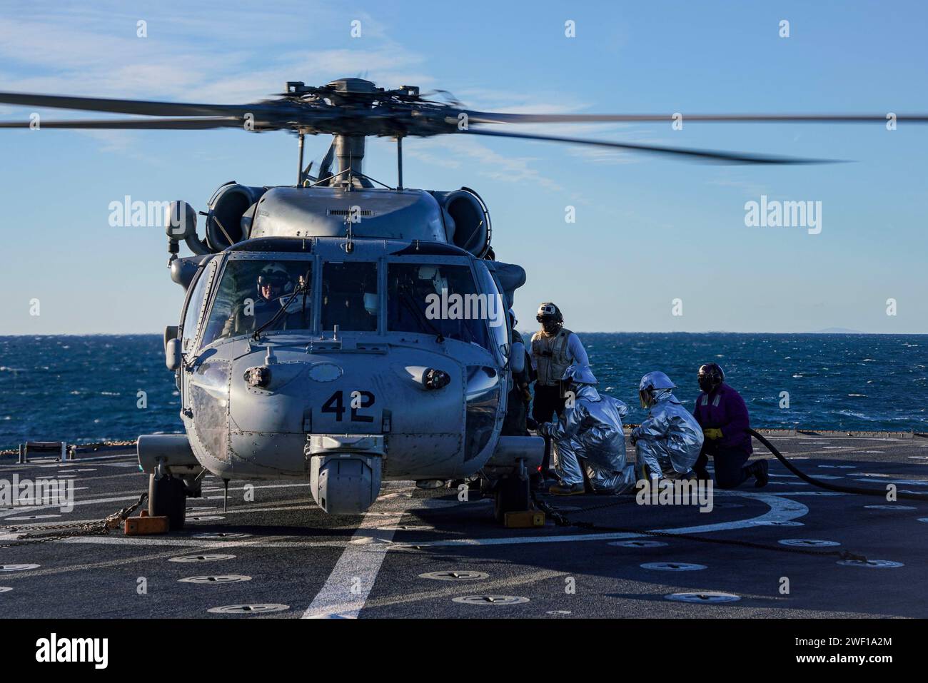 Sailors refuel an SH-60S Seahawk, assigned to Helicopter Sea Combat ...