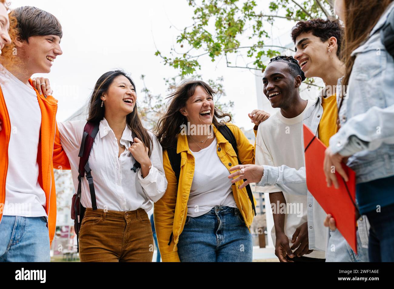 Diverse students laughing together in the campus Stock Photo - Alamy