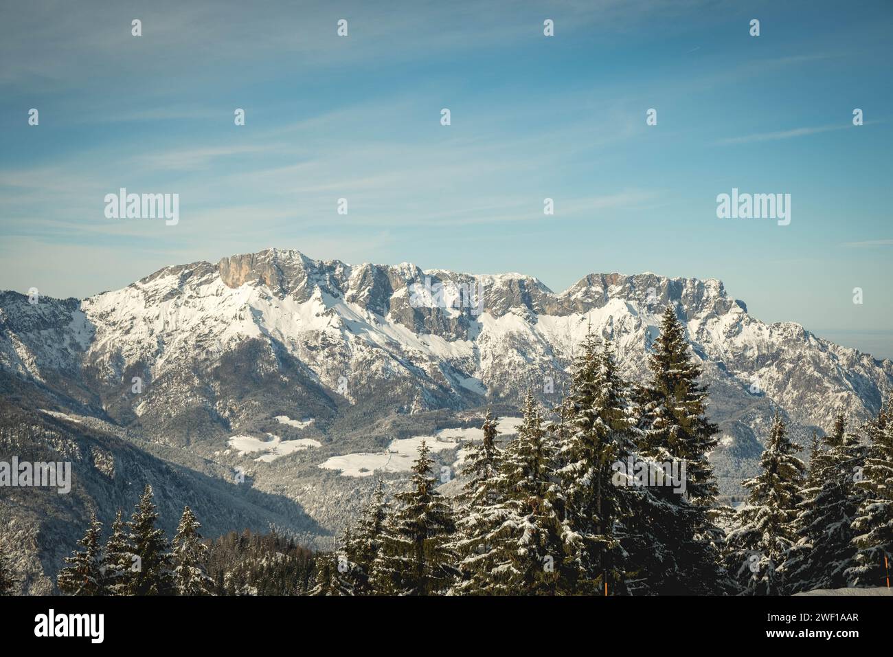 Large mountain wall rises to the sky in snowy nature in the Alps, snow ...