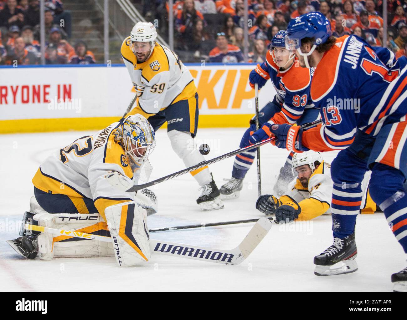 Nashville Predators goalie Kevin Lankinen, front left, watches the puck ...