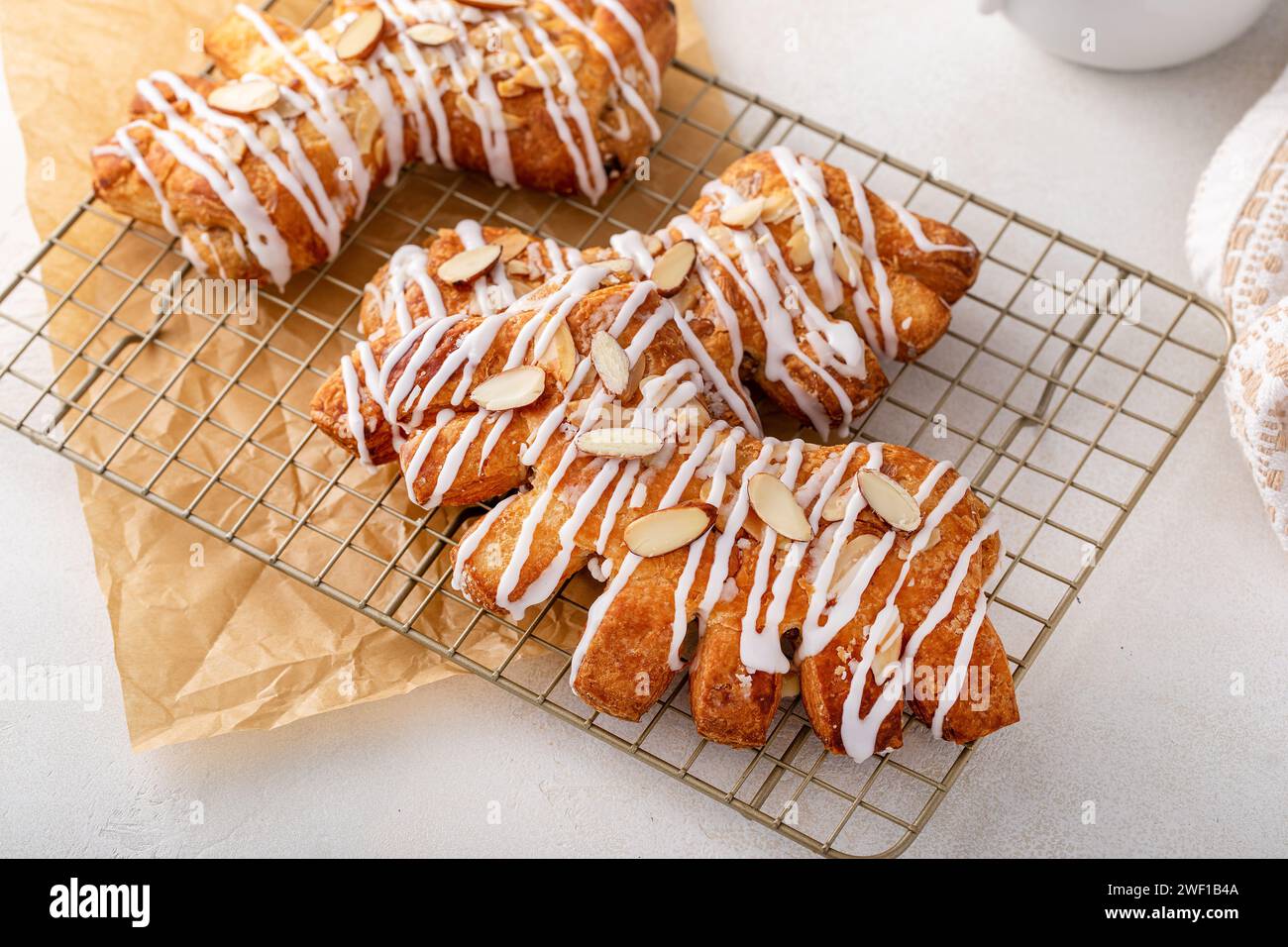 Bear claws pastry topped with glaze and almonds freshly baked and ready ...