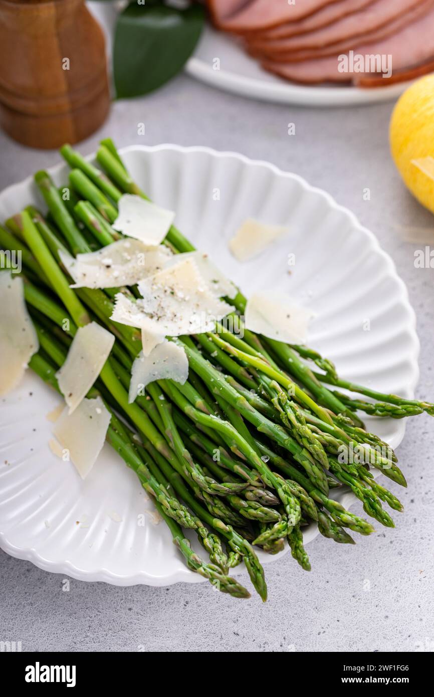 Cooked asparagus served with shaved parmesan for Easter brunch Stock ...