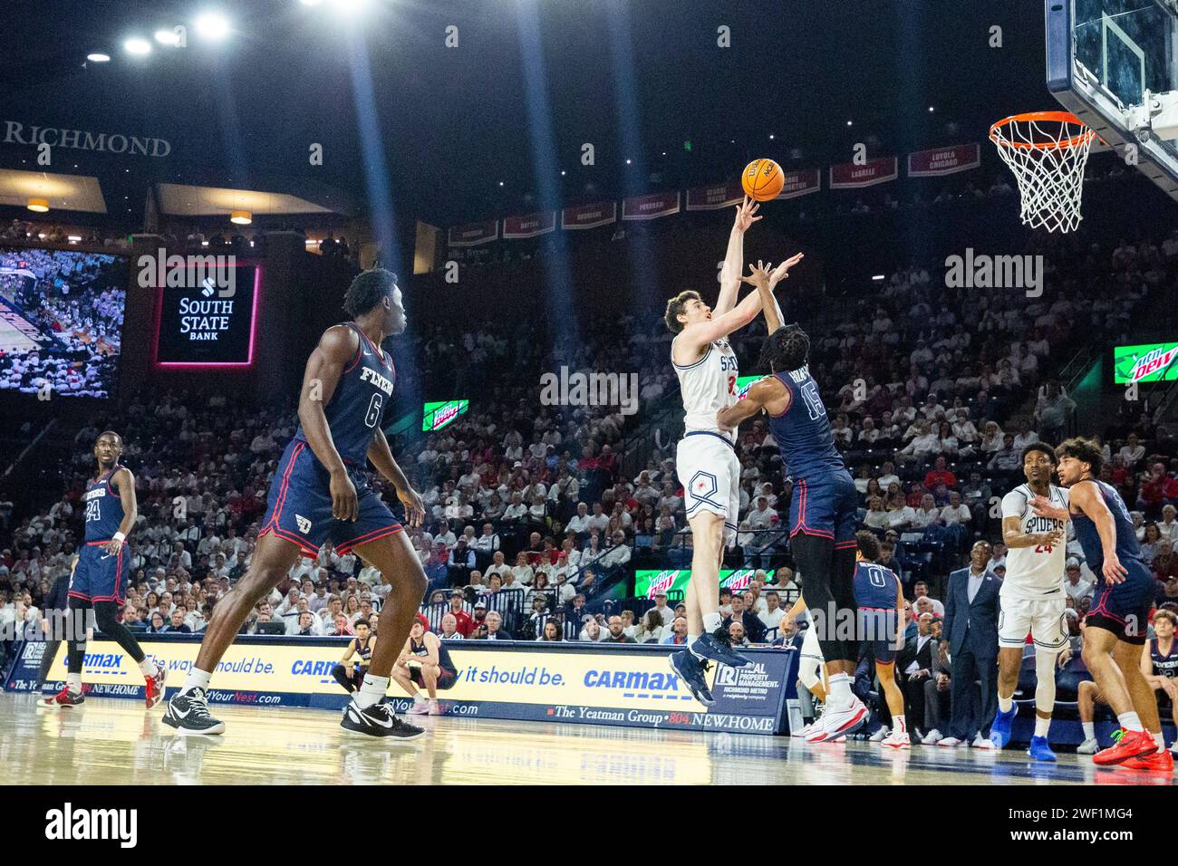 Richmond center Neal Quinn (32) shoots over Dayton forward DaRon Holmes ...